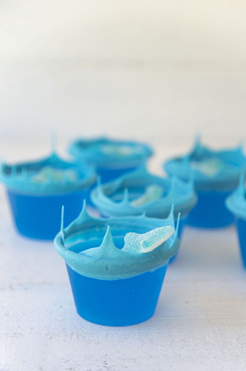 Ocean Water Jello Shots with White Chocolate Waves and Gummy Sharks