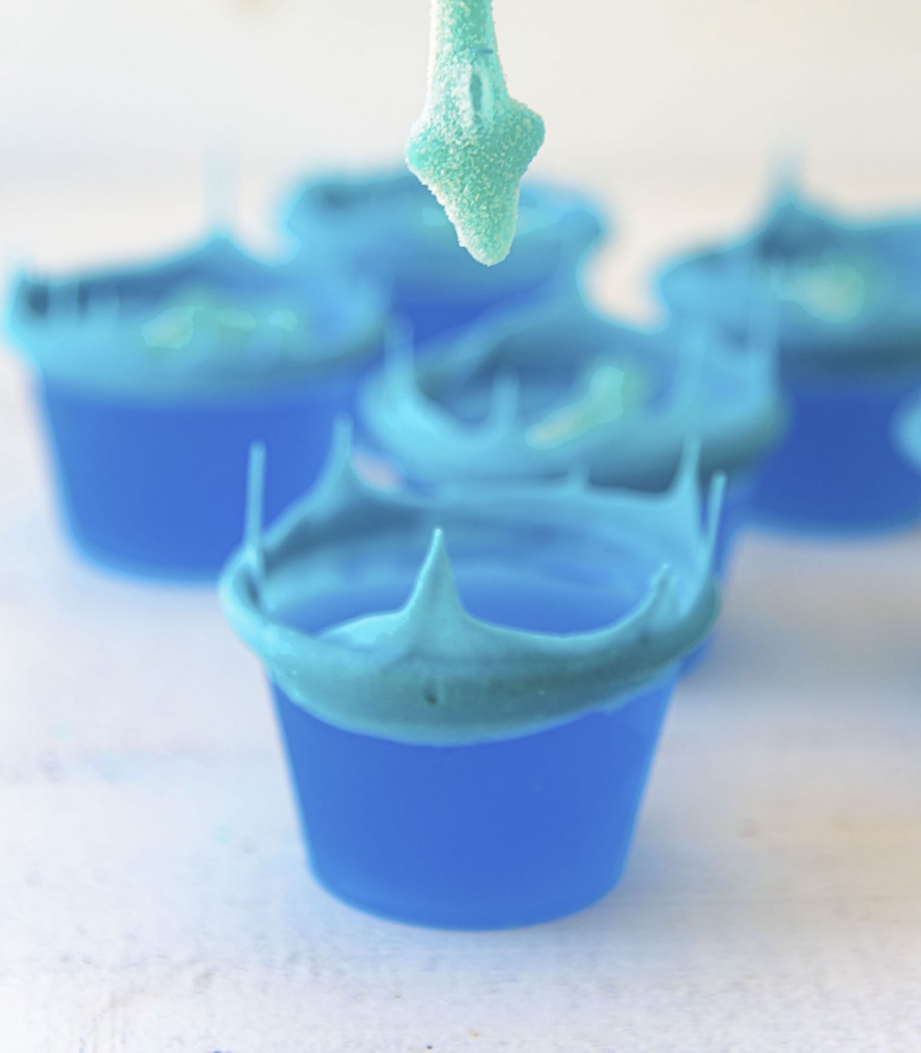 Ocean Water Jello Shots with White Chocolate Waves and Gummy Sharks